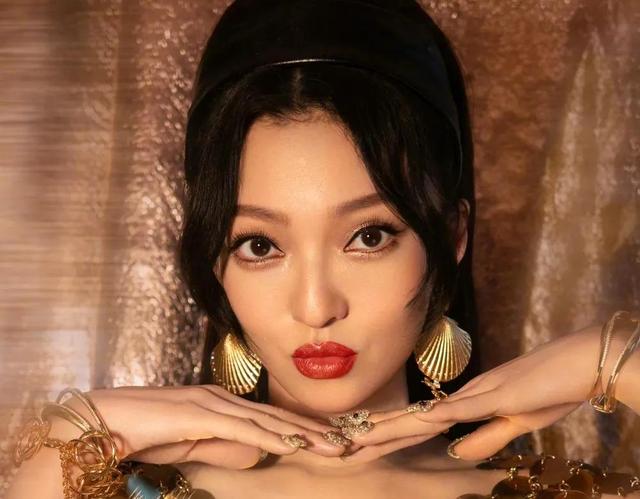 Angela Chang wears a golden sequined dress with radiant facial features ...