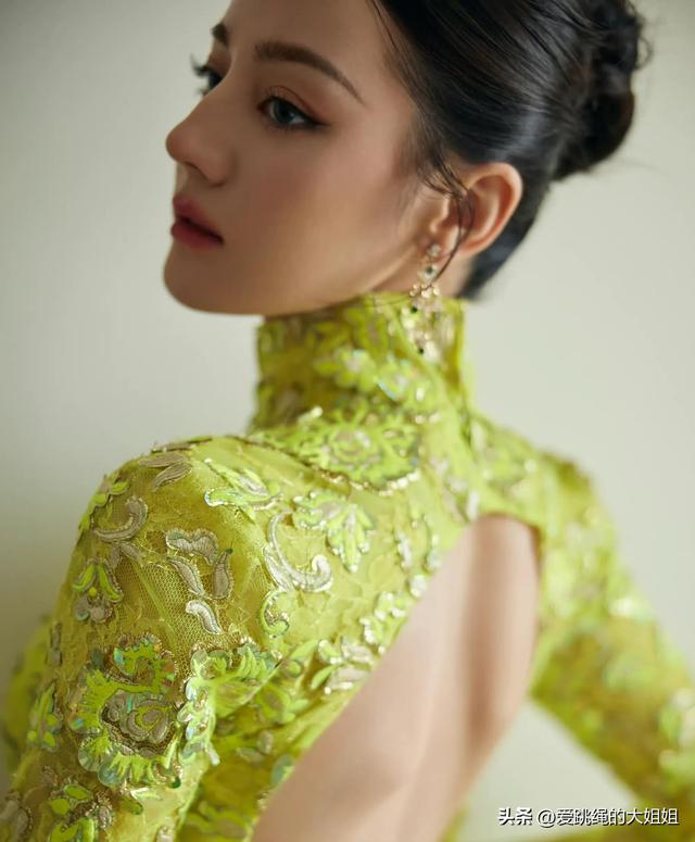 Di Ali Gerba, golden open-back cheongsam, showing infinite enchanting ...
